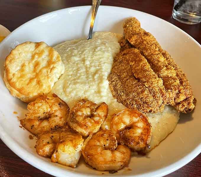 Crispy fried fish, seasoned shrimp, and creamy white cheddar grits sharing one plate like old friends.