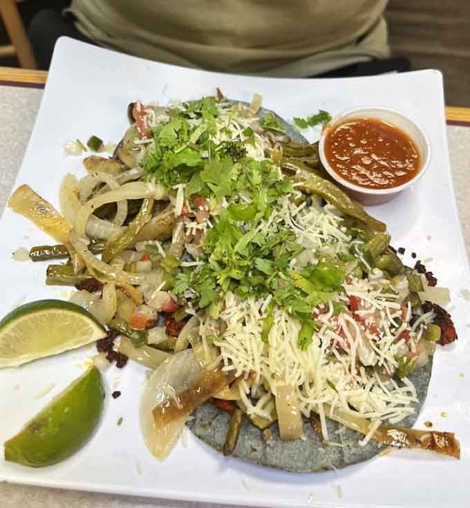The Garibaldi tacos azules arrive on deep blue corn tortillas, piled high with cecina, nopales, and fresh toppings.