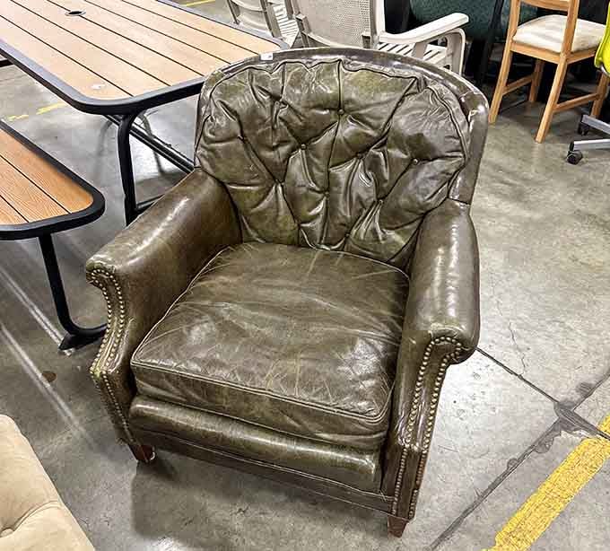 That tufted leather armchair has lived a full life and still has plenty of good sitting left in it.
