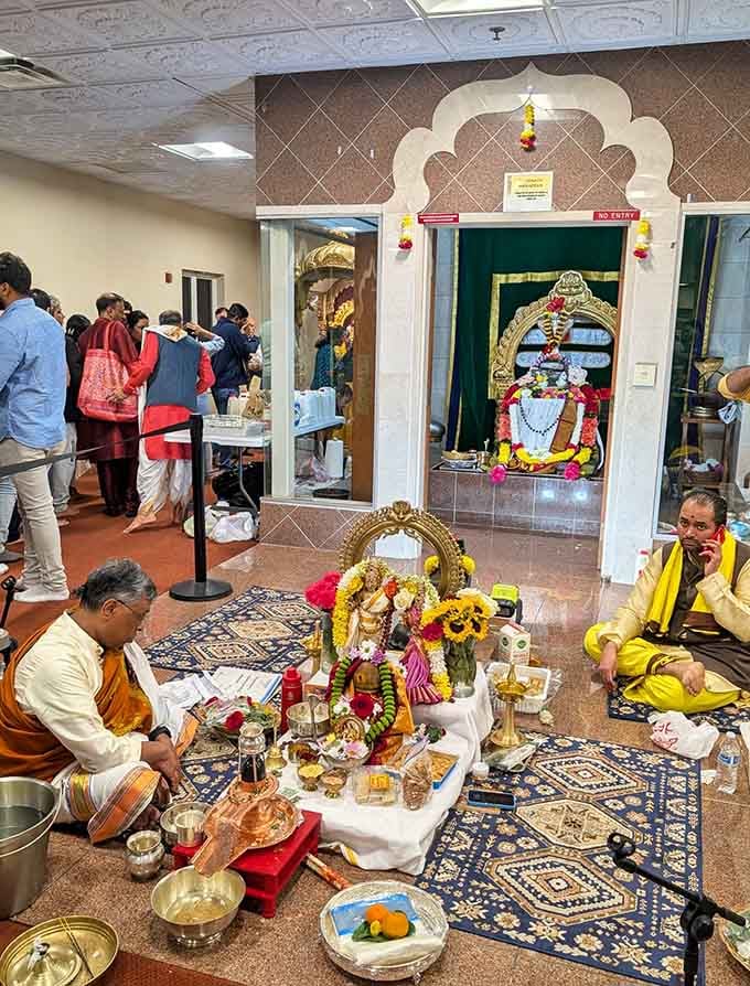 Priests and devotees gathered together, flowers and offerings arranged just so, this is the real heartbeat of the temple.