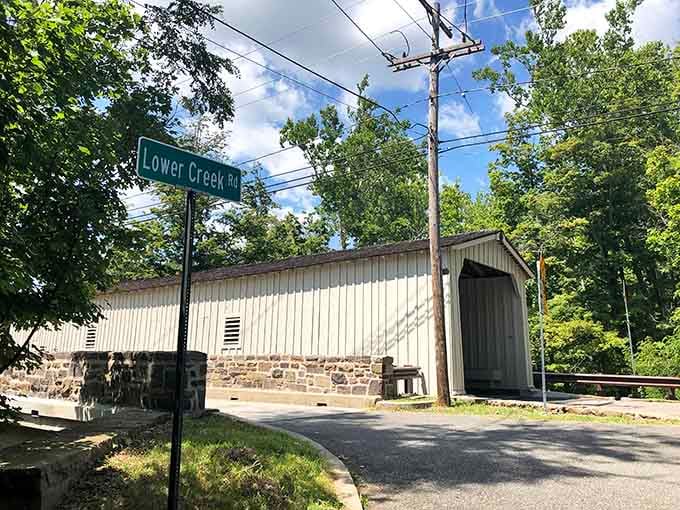 Lower Creek Road meets living history here, where a green street sign shares the frame with something genuinely irreplaceable.
