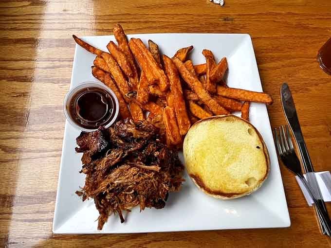 Pulled pork so tender it surrenders without a fight, paired with sweet potato fries that deserve their own fan club.