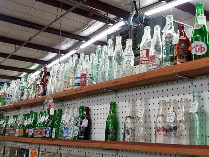 Vintage soda bottles standing at attention, a colorful lineup of brands your taste buds have long forgotten.