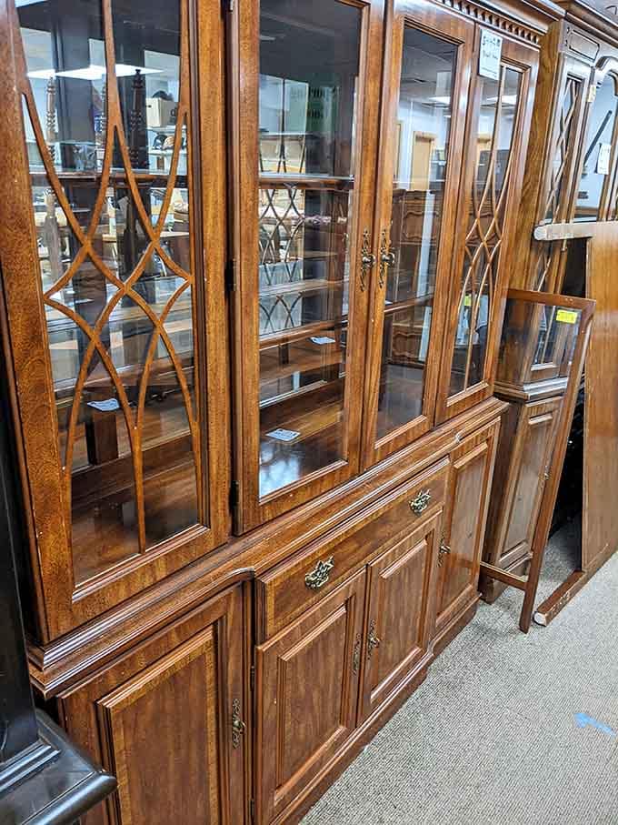This gorgeous wood and glass china cabinet has more character in its brass hardware than most brand-new furniture has anywhere.