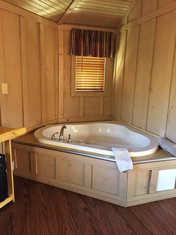 A soaking tub surrounded by natural wood paneling where relaxation meets that "I'm basically a woodland creature now" vibe.