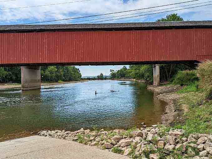 Someone's wading in the river beneath this magnificent old bridge, and honestly, that's the right idea.
