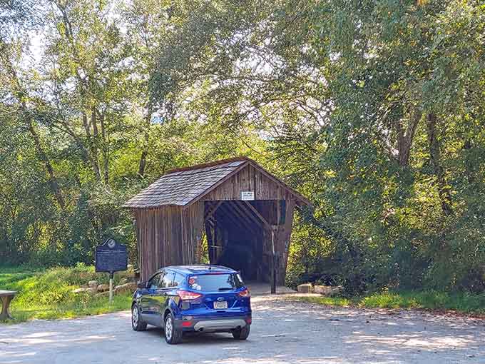 A blue car, a gravel lot, and one of Georgia's most quietly spectacular landmarks waiting patiently at the tree line.