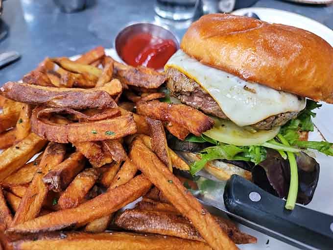 That half-pound burger with hand cut fries is the kind of plate that makes you cancel your afternoon plans.