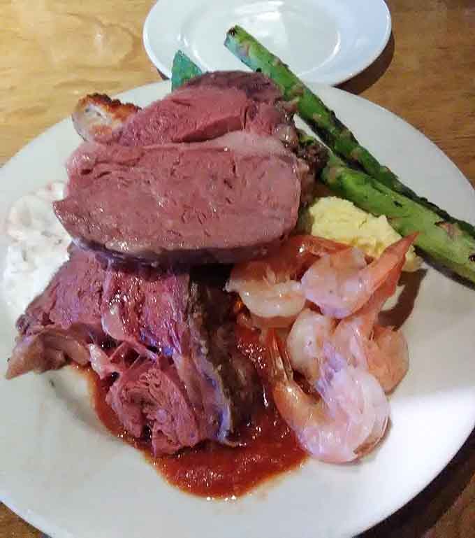 Prime rib, shrimp, asparagus, and all the trimmings sharing one plate. Somewhere, a buffet line just became legendary.