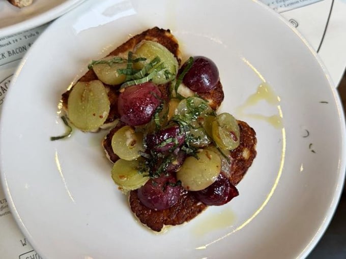 Grilled haloumi topped with roasted grapes and fresh herbs. Cheese this good deserves its own standing ovation.