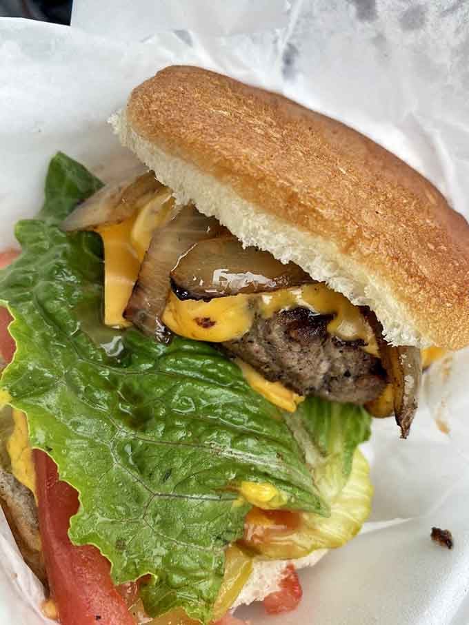 Melted American cheese draped over a juicy patty is comfort food at its finest, no apologies needed here.