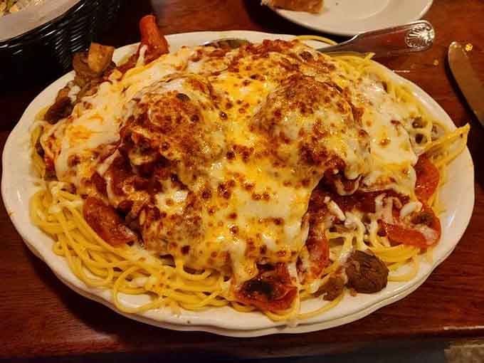 The Loaded Spaghetti Dinner buried under bubbling cheese and toppings. Your diet never stood a chance.