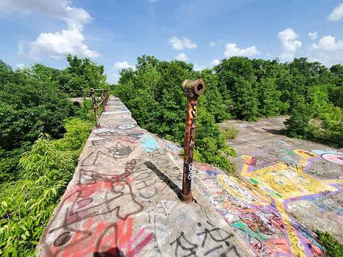 Even the rusty remnants become part of the artistic landscape, standing sentinel over this graffiti-covered wonderland.