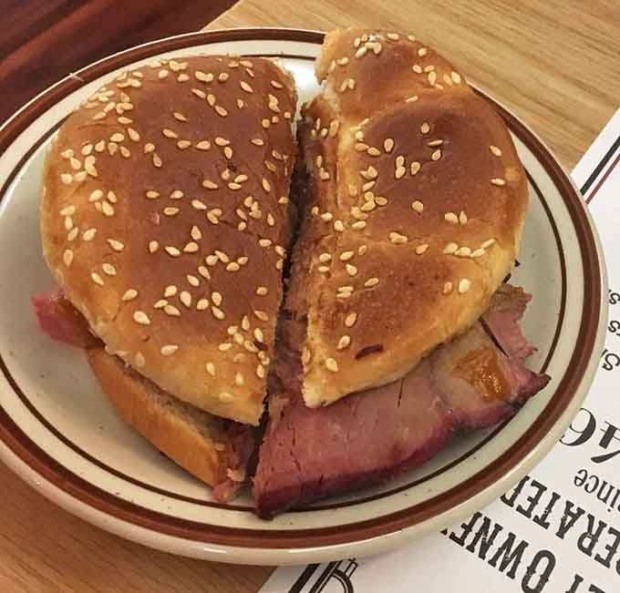A barbecue beef sandwich on a sesame bun, sliced thick and stacked proud. Simple, honest, and absolutely no apologies.