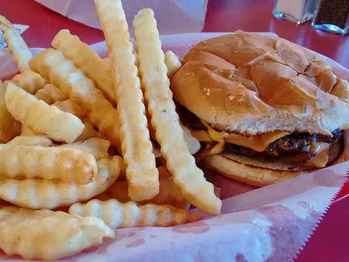 Crinkle-cut fries beside a cheeseburger: the classic duo that never gets old, never lets you down.