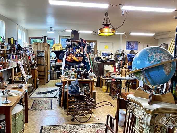 A vintage globe, an ornate hanging lamp, and a baby carriage walk into an antique mall together.