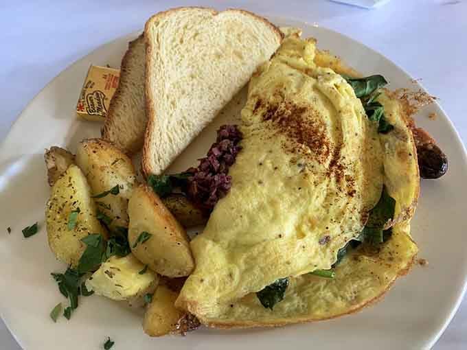 Spinach and cheese tucked into clouds of perfectly cooked eggs, this is what breakfast dreams are made of, folks.