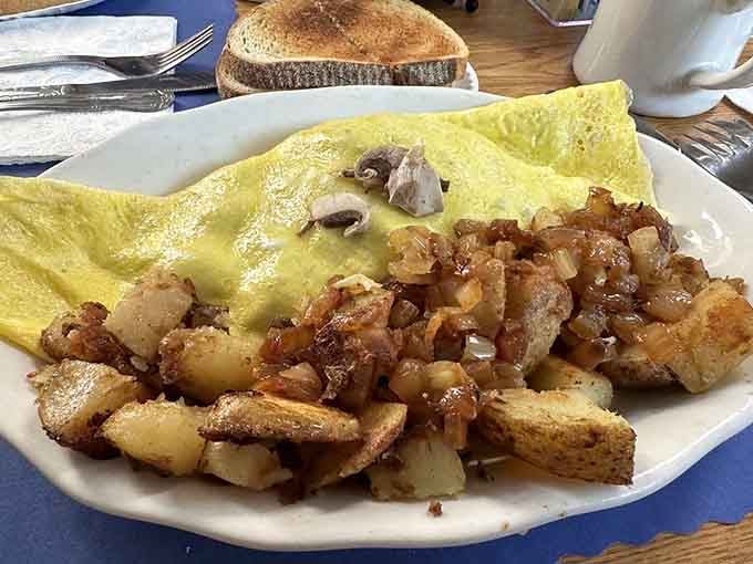 That fluffy omelet paired with perfectly crisped home fries is what breakfast dreams are actually made of.