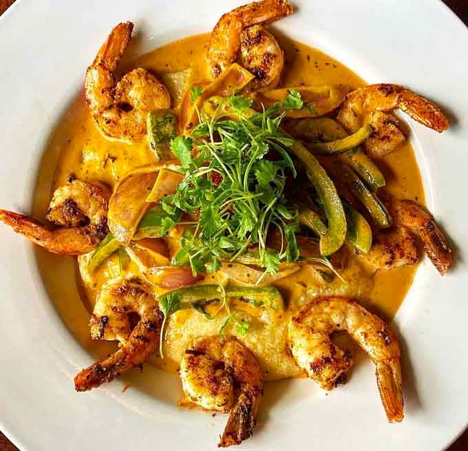 Cajun-spiced shrimp arranged over creamy grits with saut&eacute;ed peppers, this bowl is basically a Southern postcard on a plate.