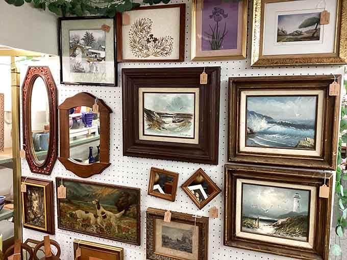 A wall full of framed paintings that would make any art gallery quietly jealous of itself.