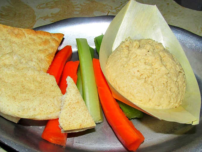 Creamy hummus with flatbread and fresh vegetables, proof that good eating has always been timeless.