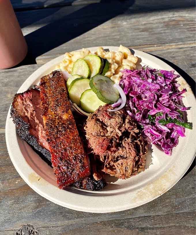 This three-meat plate with vibrant purple slaw is what happens when pitmasters take their craft seriously and creatively.