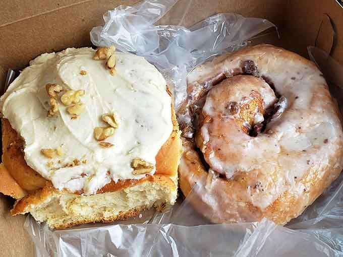 Two giants sharing one box: a frosted walnut roll and a glazed beauty, no competition necessary.