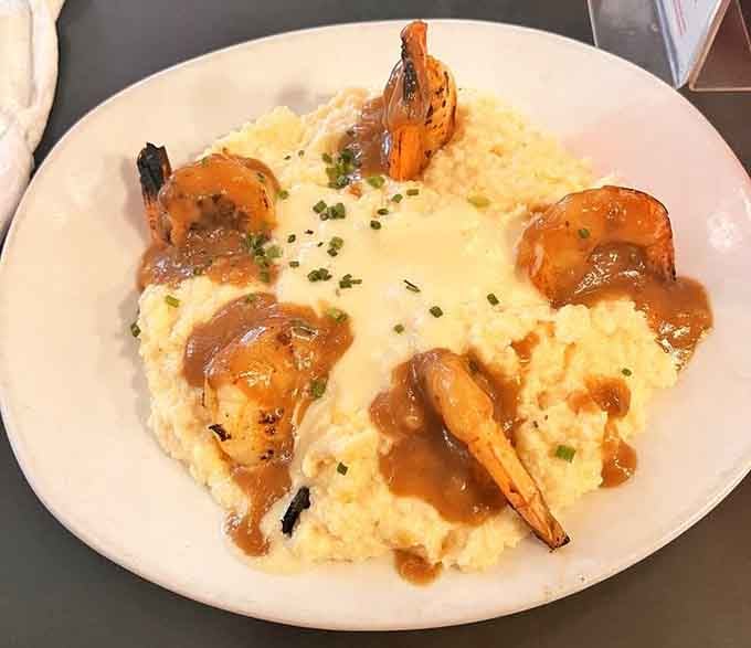 Five perfectly charred shrimp arranged around a cloud of cheesy grits. This is what happiness looks like on a plate.