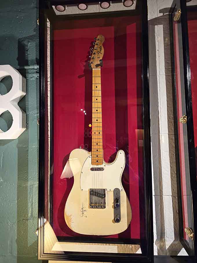 A signed vintage Fender Telecaster behind glass, because some guitars have earned their retirement after a life well lived.