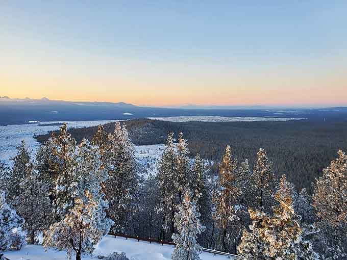 Snow-dusted pines glowing at sunset inside the caldera, the kind of winter scene that makes you reconsider everything.