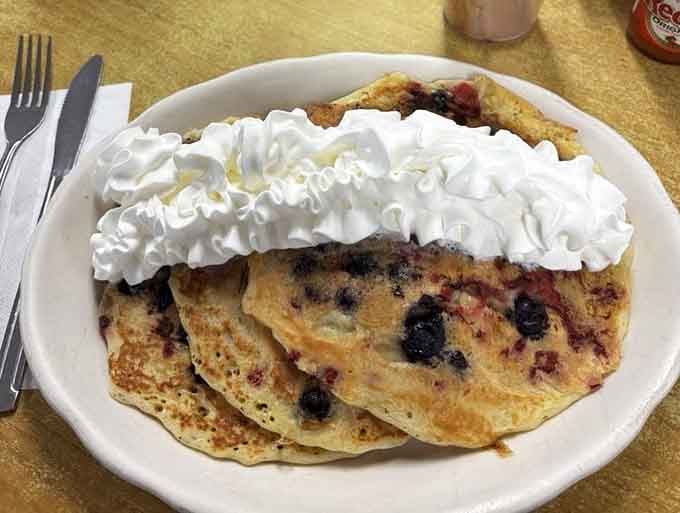 Blueberry pancakes so loaded with fruit and whipped cream, they make every other breakfast look like it's not even trying.