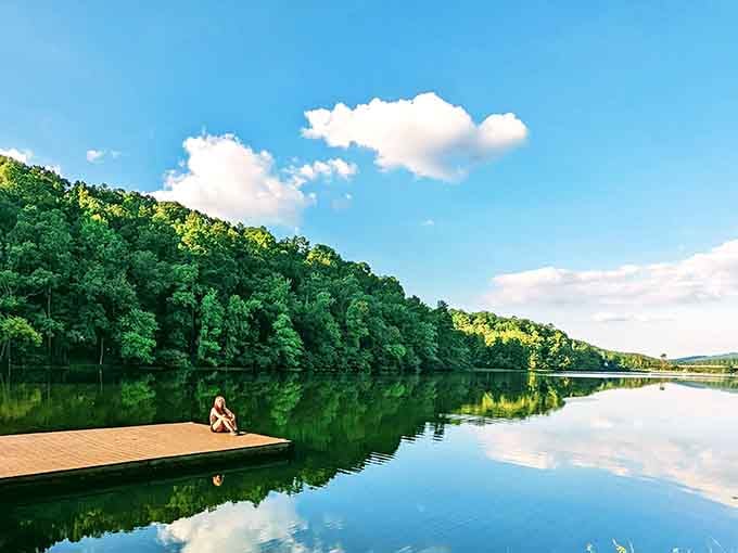 A lone figure on a dock, a mirror-perfect lake, and not a single worry in sight.