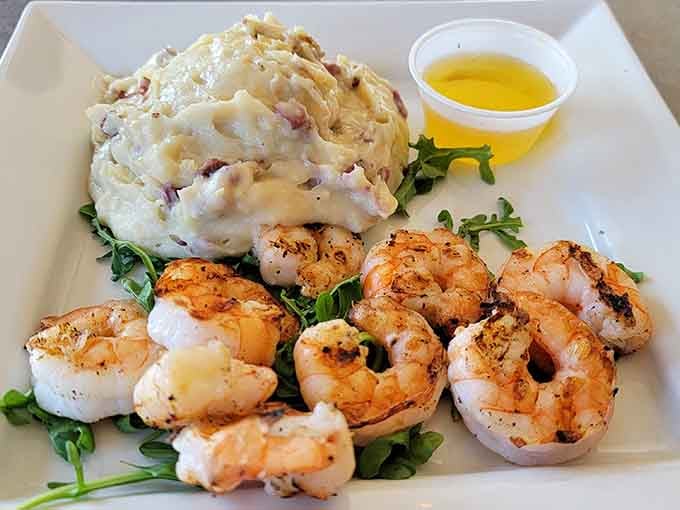Plump grilled shrimp alongside creamy mashed potatoes and a side of drawn butter, simple, honest, and absolutely irresistible.