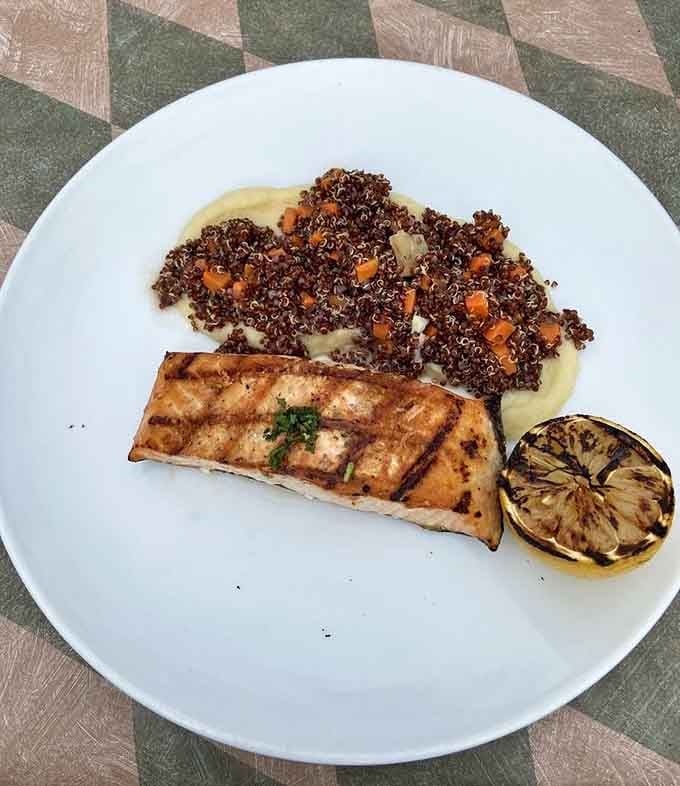 Perfectly grilled salmon with red quinoa and a charred lemon half, simple, confident, and absolutely gorgeous on the plate.