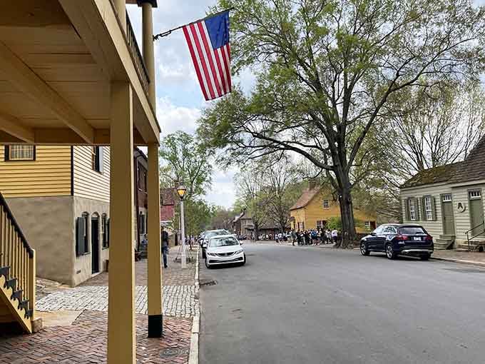 An American flag, original buildings, and curious visitors soaking it all in. Some streets just feel important.