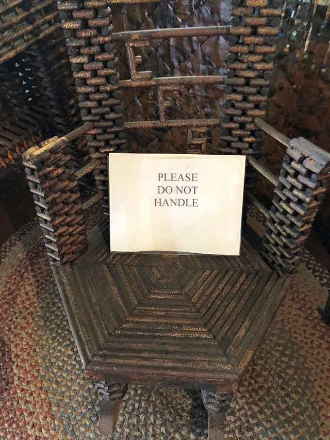 The "Please Do Not Handle" sign on this newspaper chair is doing a lot of heavy lifting, and honestly, fair enough.