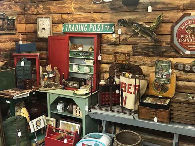 A wall full of Wisconsin soul. Trading Post signs, cranberry crates, and fishing memories all in one spot.