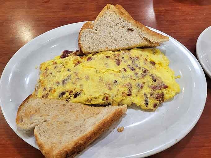 Fluffy, golden, and packed with savory bits, this omelet arrived with toast and absolutely zero apologies.