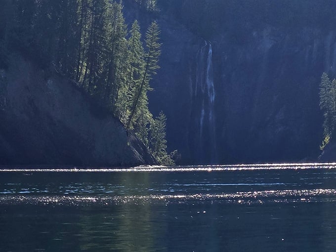 From across Sullivan Lake, Peewee Falls looks almost shy, tucked between cliffs and trees like a well-kept secret.