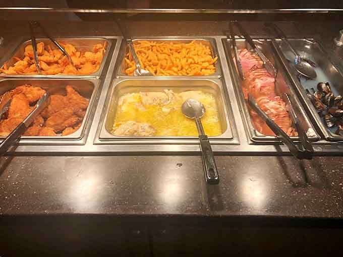 Fried chicken, mac and cheese, and carved ham all waiting patiently under the lights like stars of their own show.