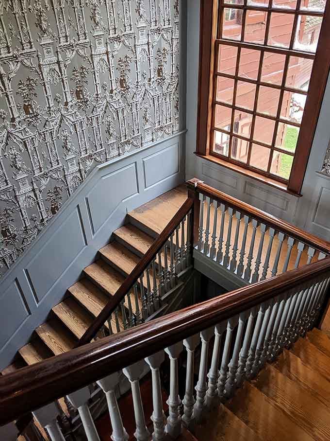 That staircase wallpaper is so detailed and dramatic, it makes every other wallpaper you've ever seen feel deeply inadequate.