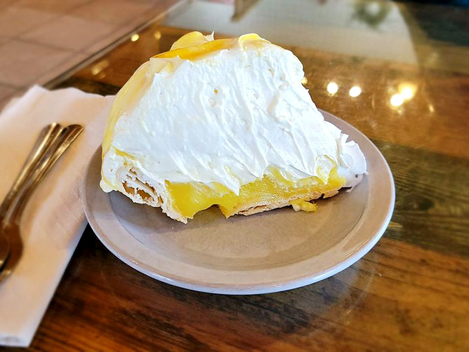 Lemon cream pie piled high with whipped topping. Sunshine on a plate, no weather app required.