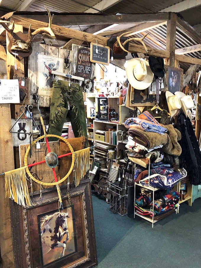 Antlers, fringe chaps, and hand-painted signs create a frontier atmosphere so authentic you half expect a tumbleweed to roll through.