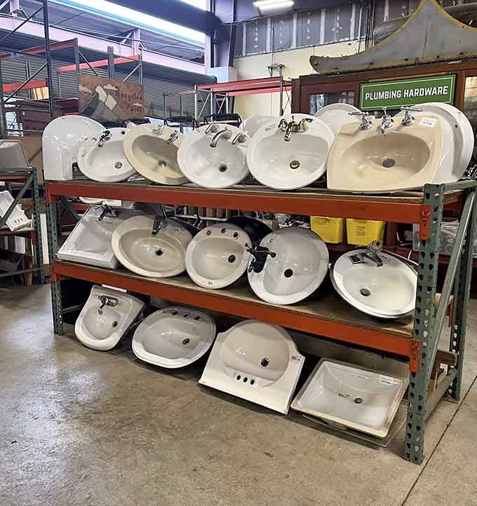 Three shelves of porcelain bathroom sinks, all shapes and sizes, patiently waiting for their next starring role in your home.