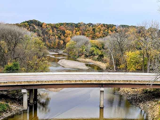 Fall colors frame this engineering marvel like nature's own picture frame, absolutely stunning.