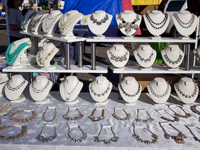 Sparkling necklaces lined up like royalty, waiting patiently for someone to give them a good home.