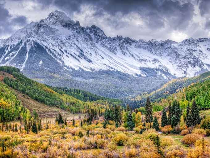 Mount Sneffels area in full autumn glory, wearing gold and snow like it invented the combination.