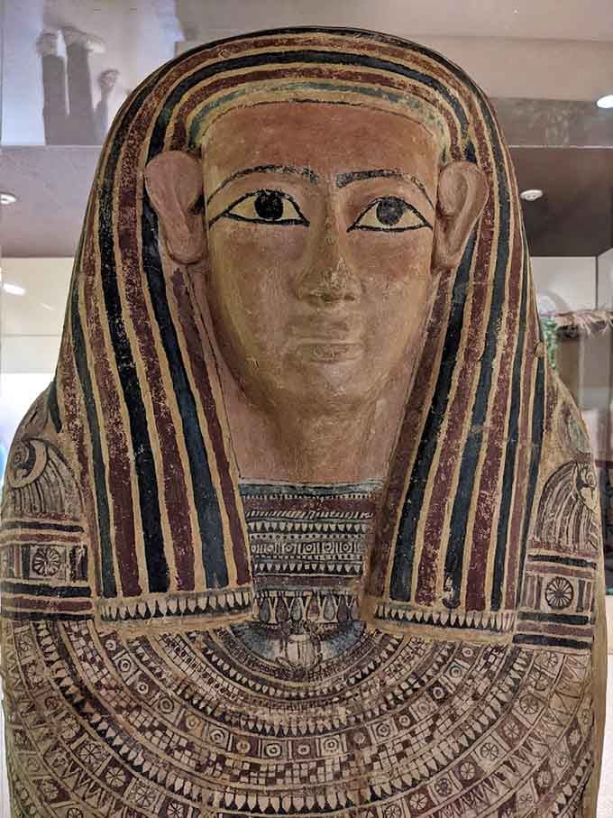 A beautifully painted coffin lid stares back at you, its bold colors and intricate patterns still vivid after thousands of years.