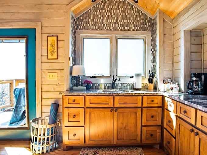 Granite countertops and a mosaic tile backsplash, because roughing it was never supposed to mean this.