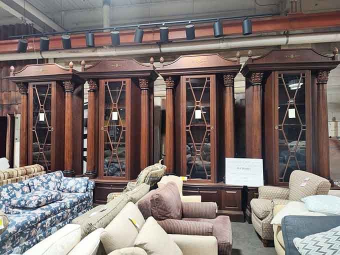 Those floor-to-ceiling carved wood cabinets belong in a library where someone dramatically reads old letters by candlelight.